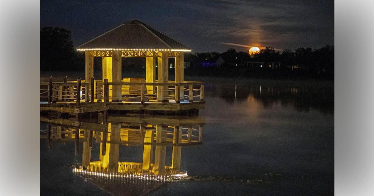 Full moon setting over Lake Sumter - Villages-News.com